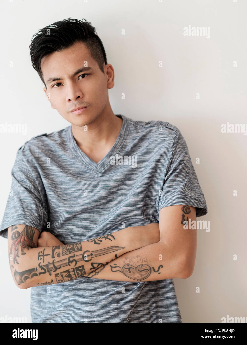Young asian guy crossed arms hi-res stock photography and images - Alamy