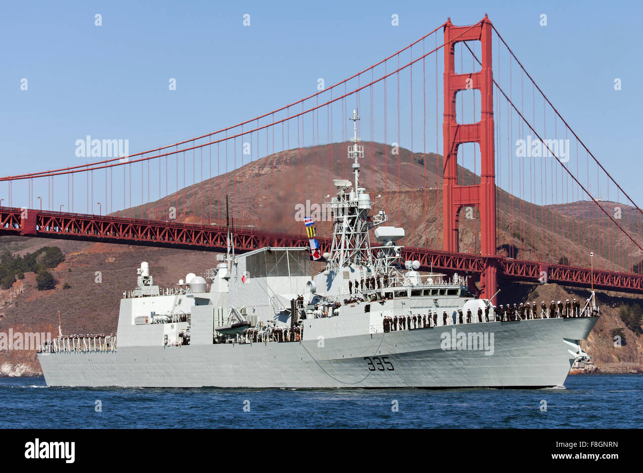 Halifax-class frigate HMCS Calgary (FFH 335) passes under the Golden ...