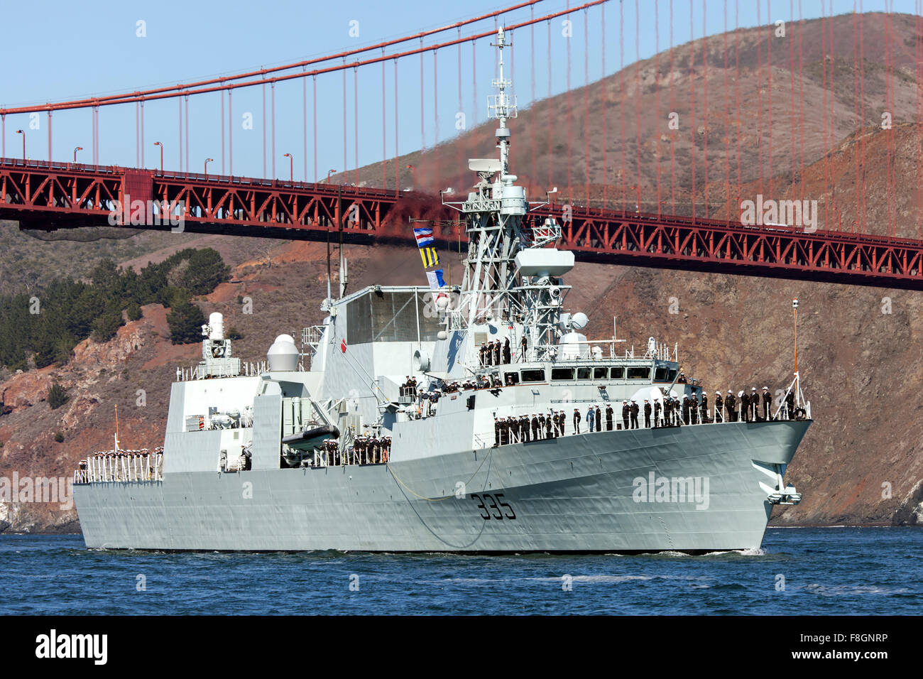 Halifax-class frigate HMCS Calgary (FFH 335) passes under the Golden ...