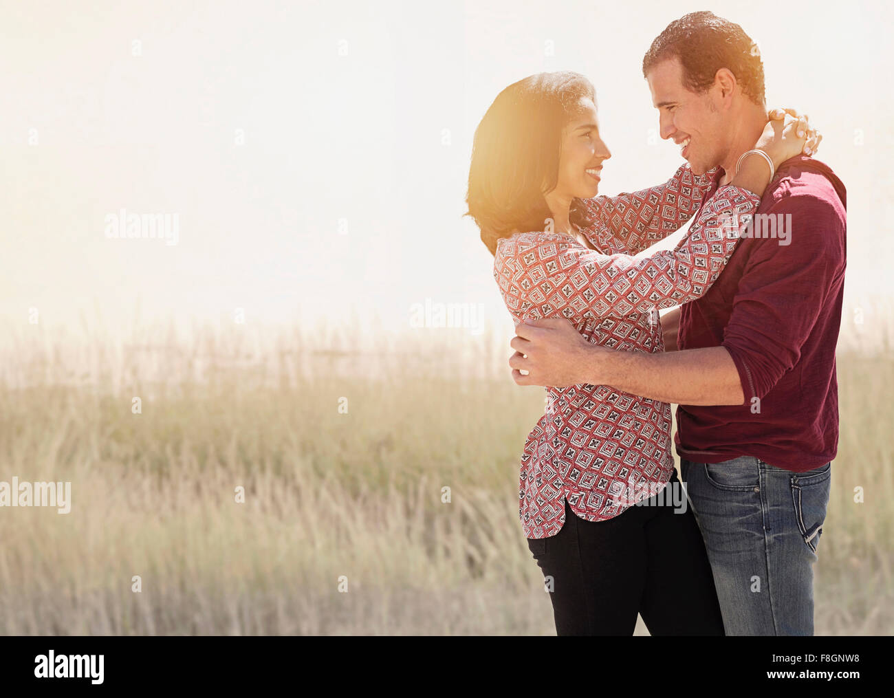 Hispanic couple hugging outdoors Stock Photo - Alamy