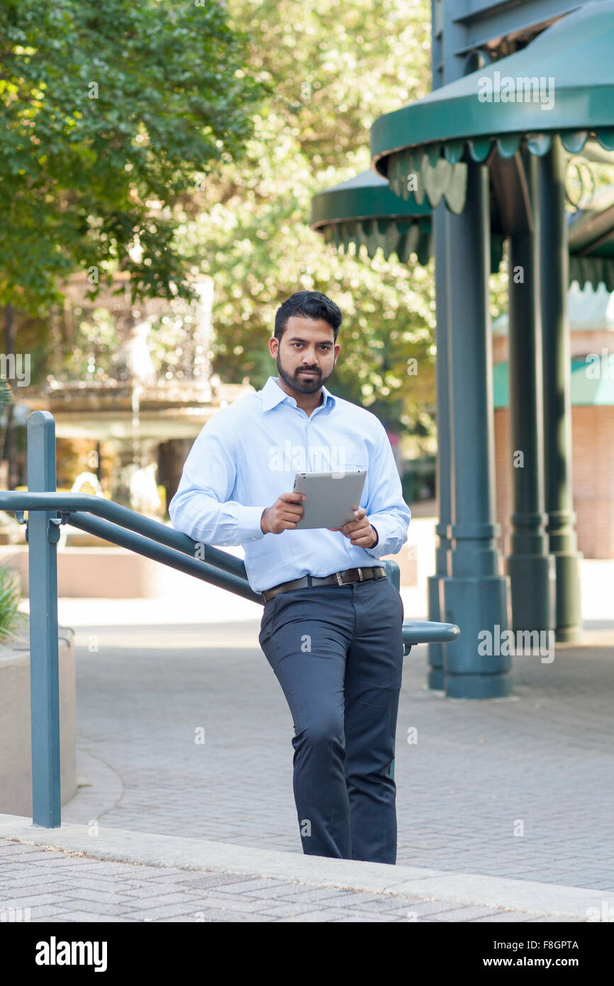 Indian guy reading tablet hi-res stock photography and images - Alamy