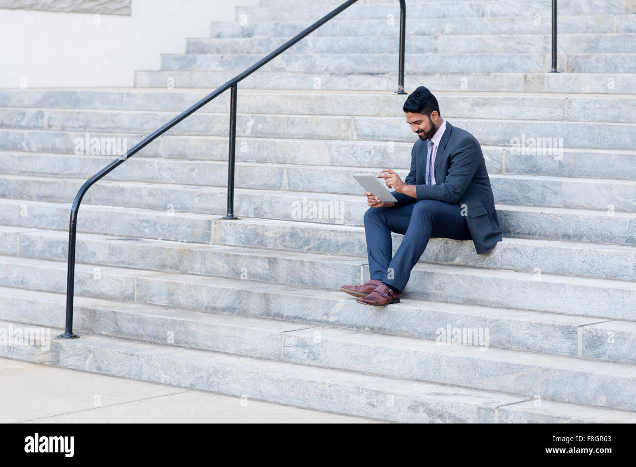 Indian man sitting on steps hi-res stock photography and images - Alamy