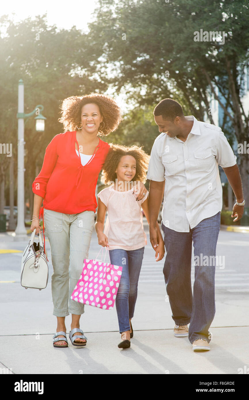 Smiling family walking outdoors Stock Photo - Alamy