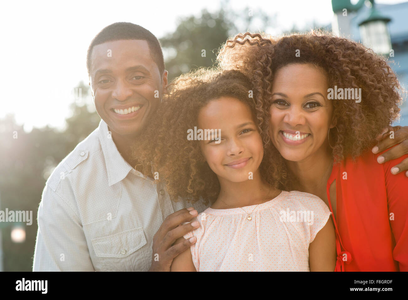 Smiling family standing outdoors Stock Photo - Alamy