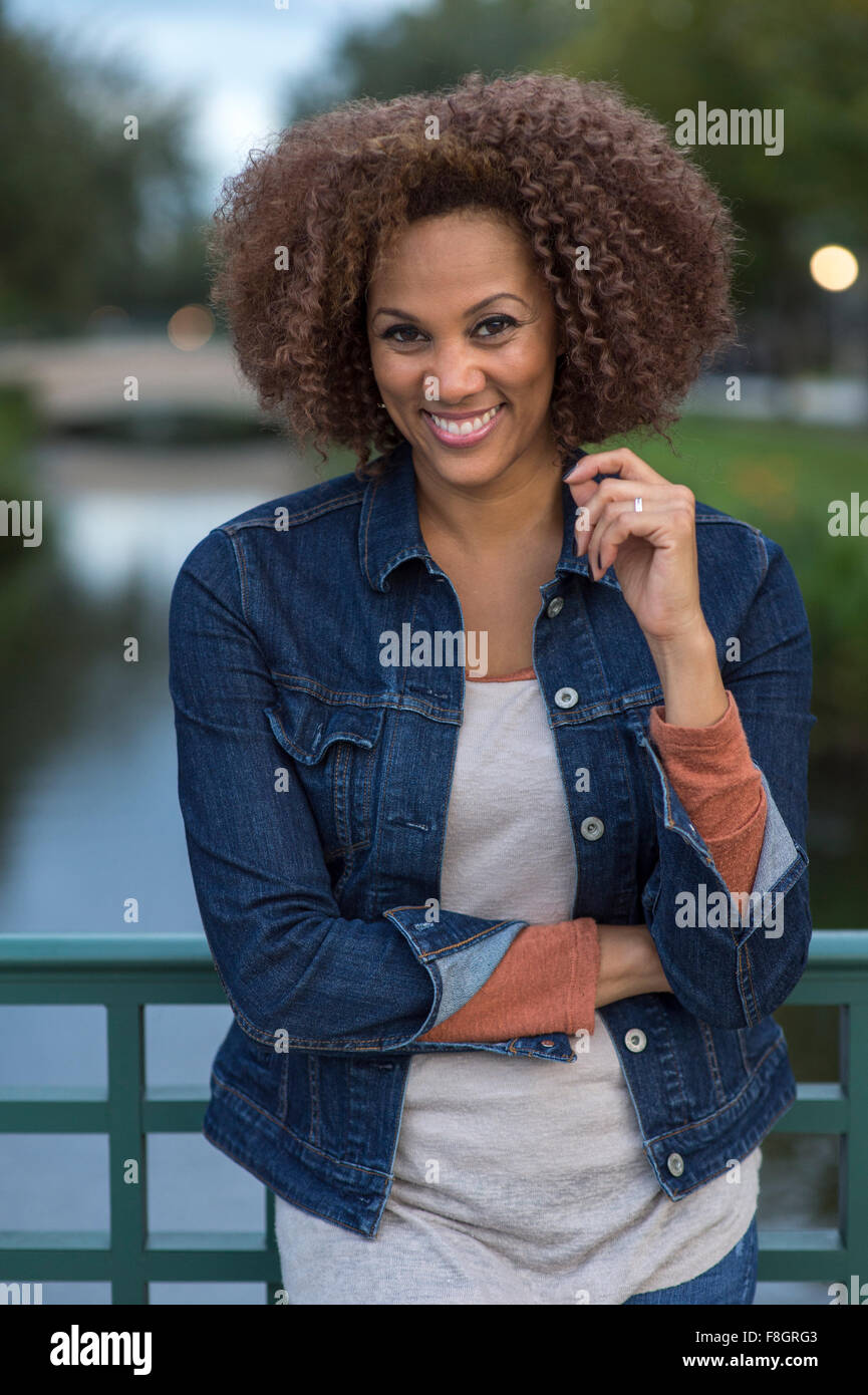 Mixed race woman standing on bridge Stock Photo - Alamy
