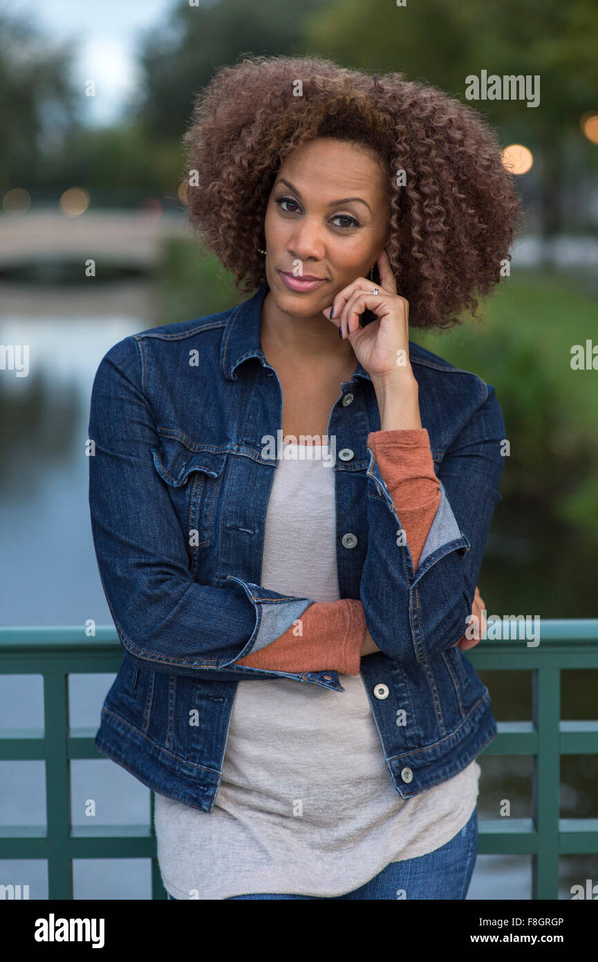 Mixed race woman standing on bridge Stock Photo - Alamy