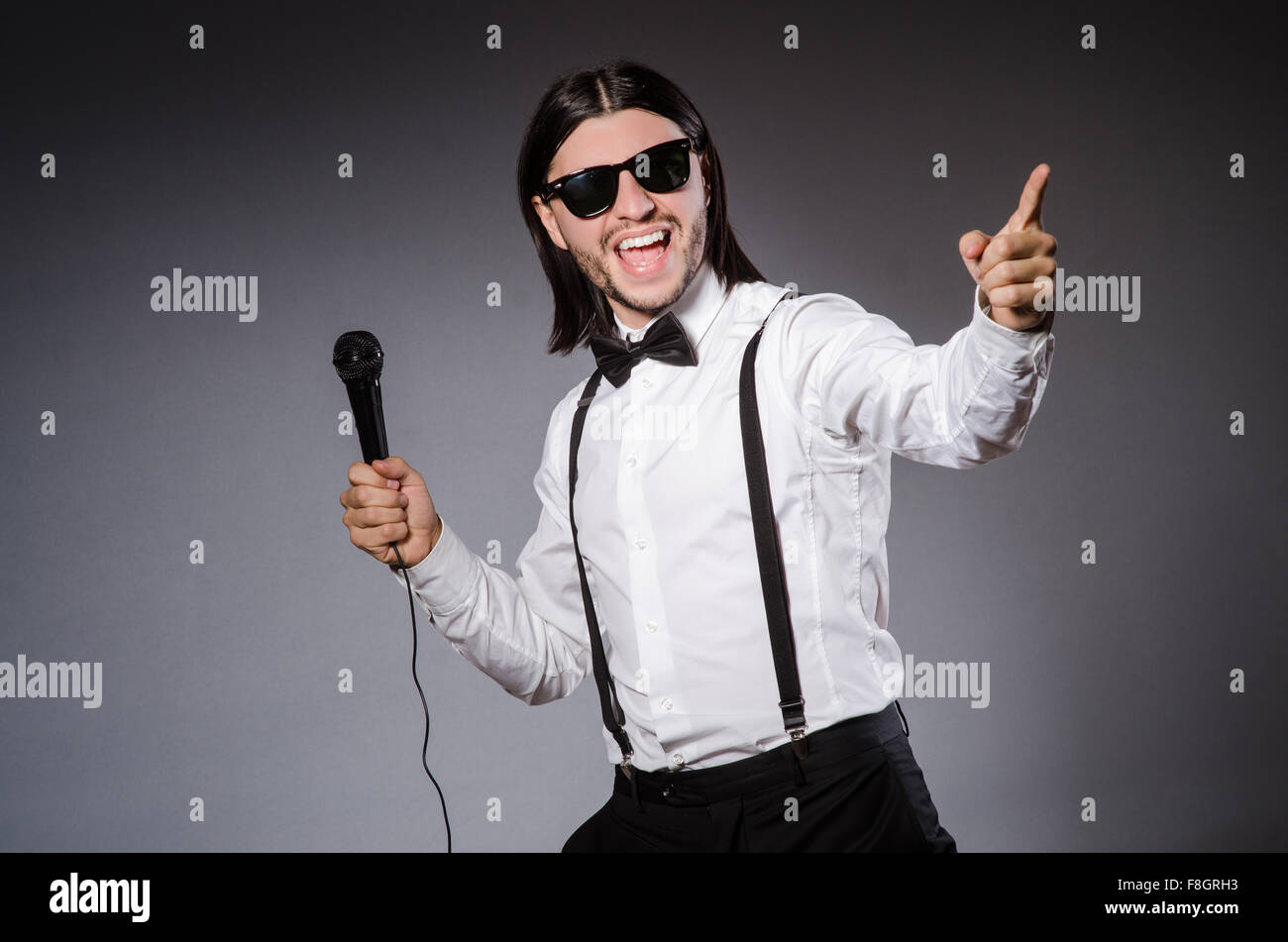 Funny singer with microphone at the concert Stock Photo - Alamy