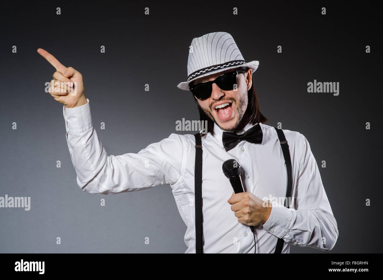 Funny singer with microphone at the concert Stock Photo - Alamy