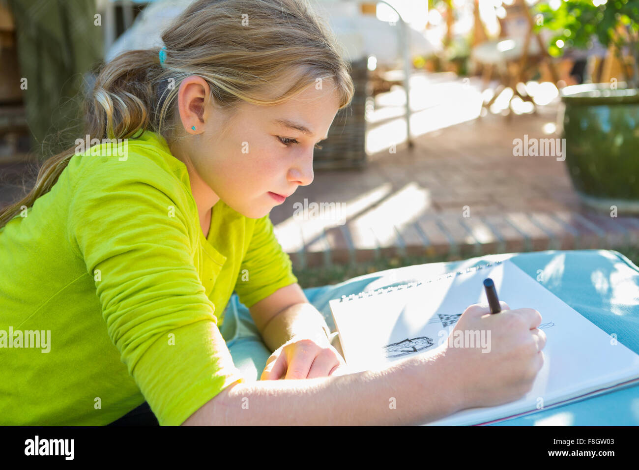 Caucasian girl drawing outdoors Stock Photo - Alamy
