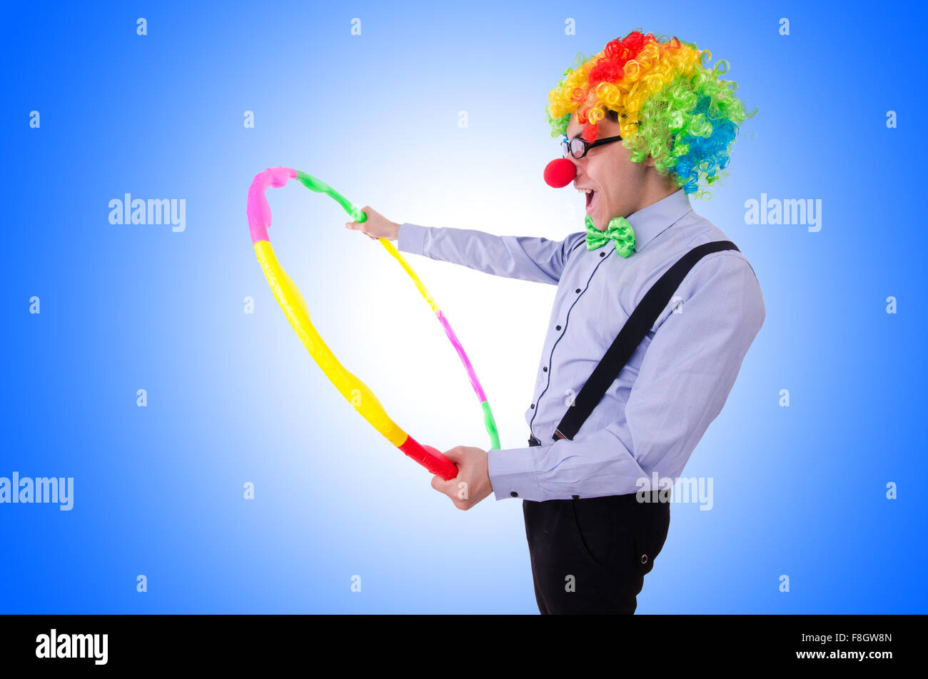 Funny clown with hula hoop on white Stock Photo - Alamy