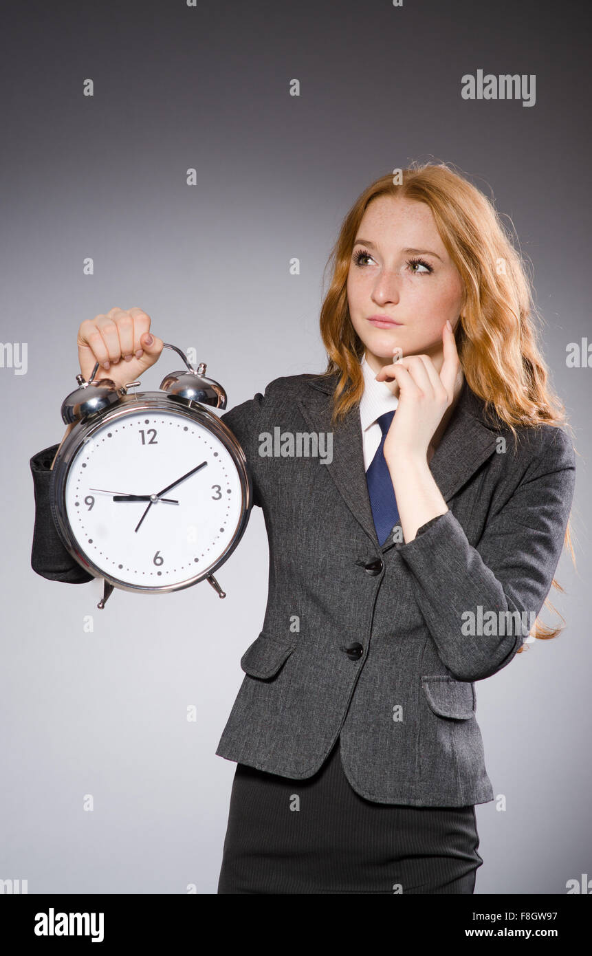 Businesswoman with clock being late for her deliverables Stock Photo ...