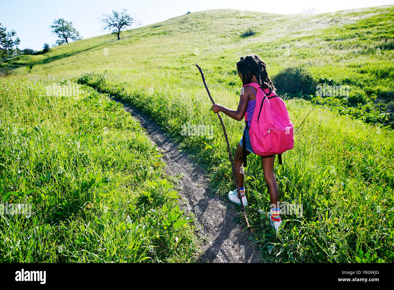 Black girl walking on rural path Stock Photo - Alamy