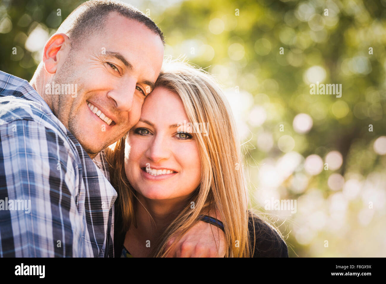 Smiling couple hugging outdoors Stock Photo - Alamy