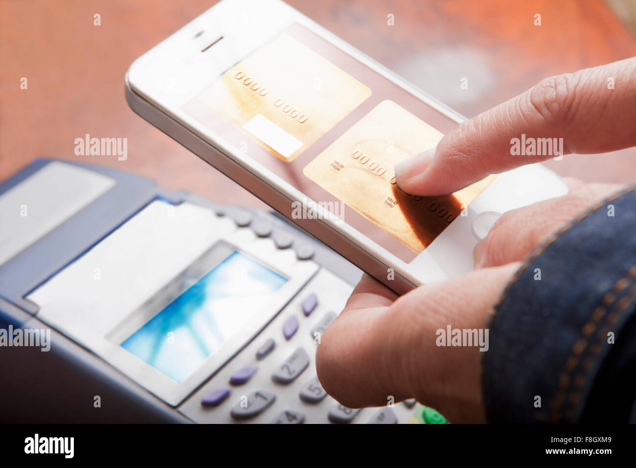 Hispanic woman paying with cell phone Stock Photo - Alamy