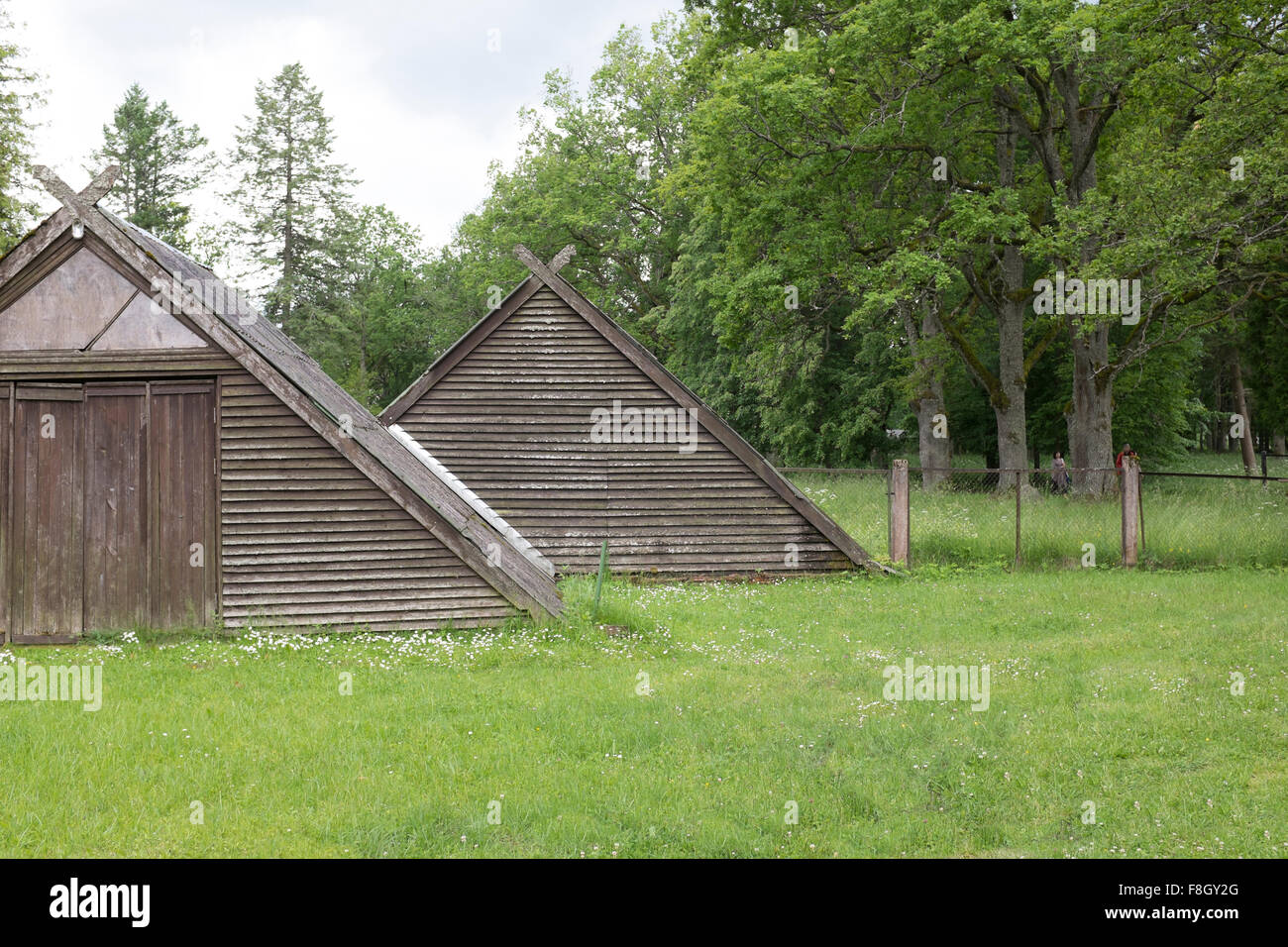 Traditional wooden buildings in field Stock Photo - Alamy