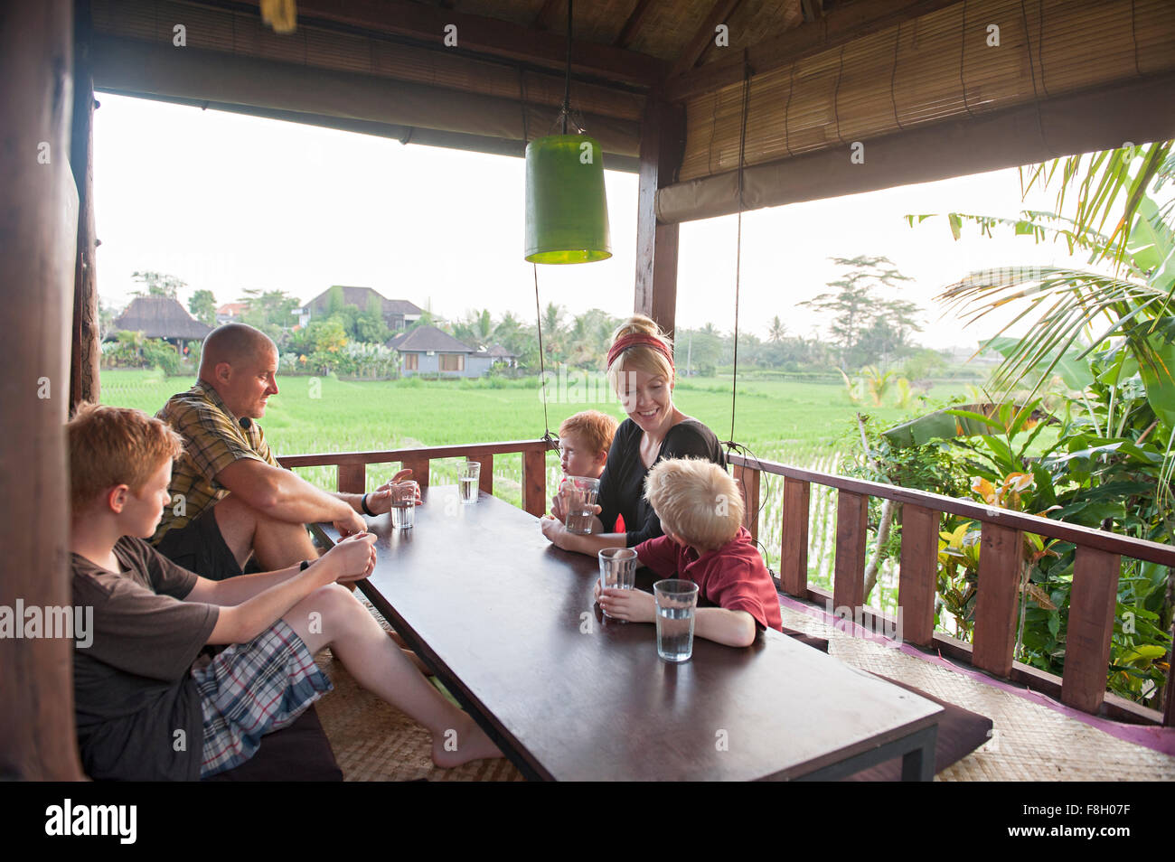 Caucasian family eating in covered patio Stock Photo - Alamy