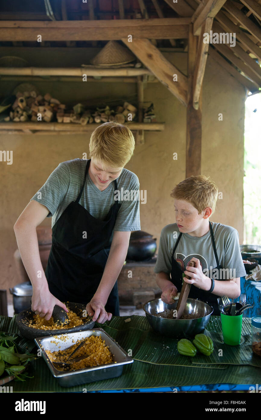 Caucasian brothers cooking in outdoor kitchen Stock Photo - Alamy