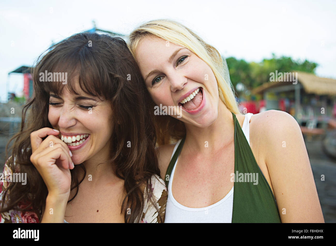 Caucasian women laughing on beach Stock Photo - Alamy