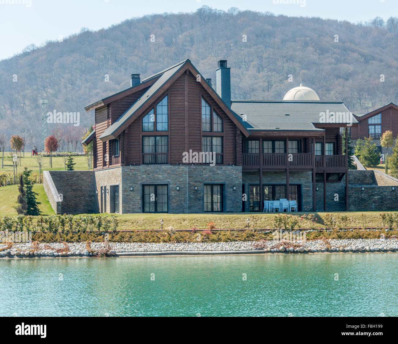 Modern house near water on bright day Stock Photo - Alamy