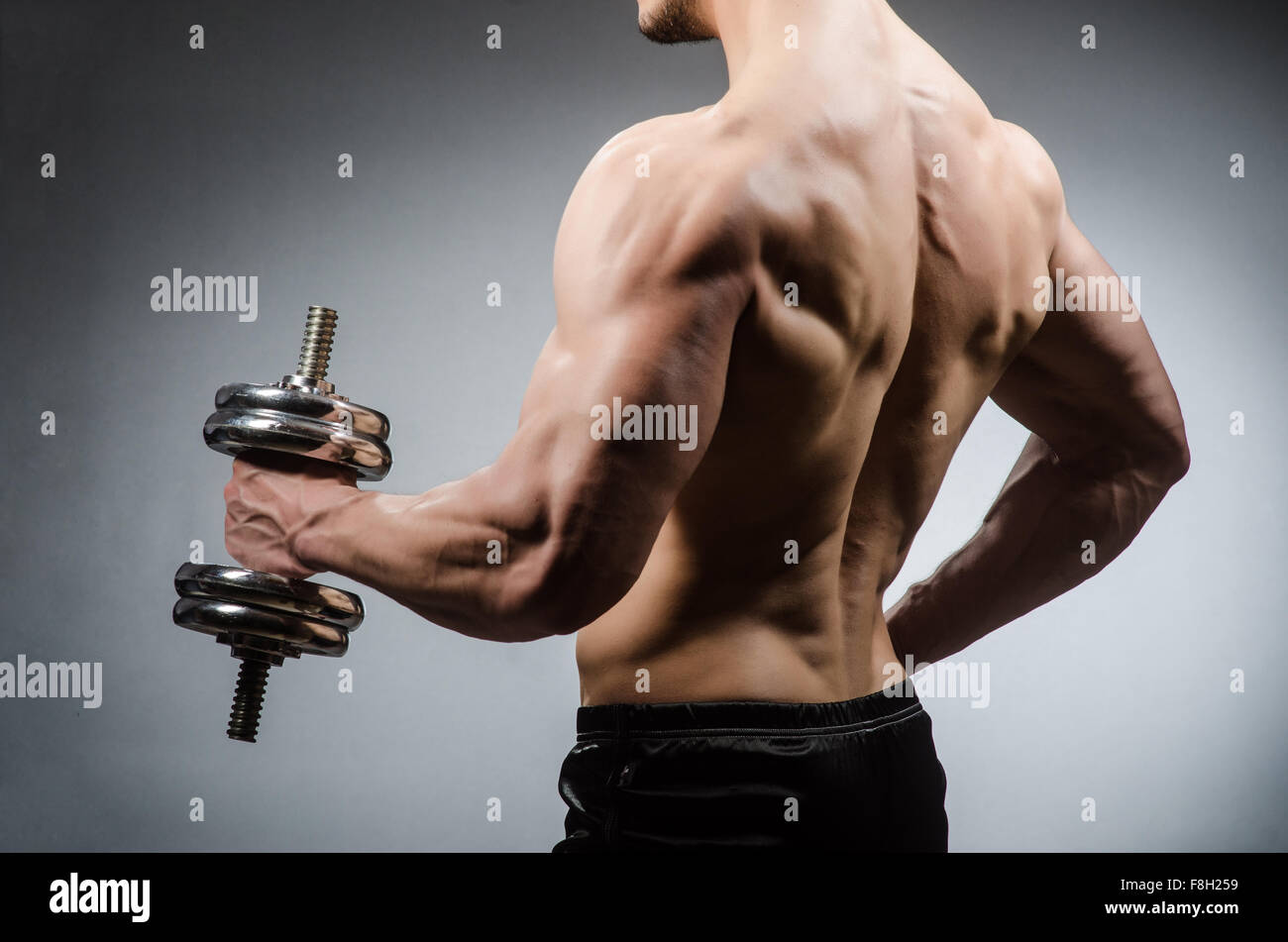 Muscular ripped bodybuilder with dumbbells Stock Photo - Alamy