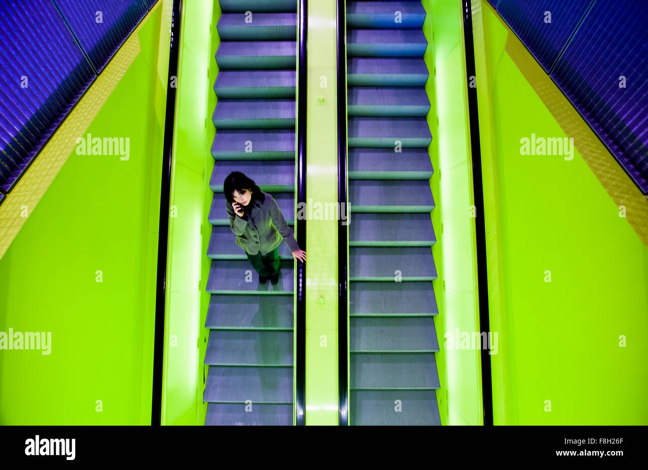 Japanese woman riding escalator Stock Photo - Alamy