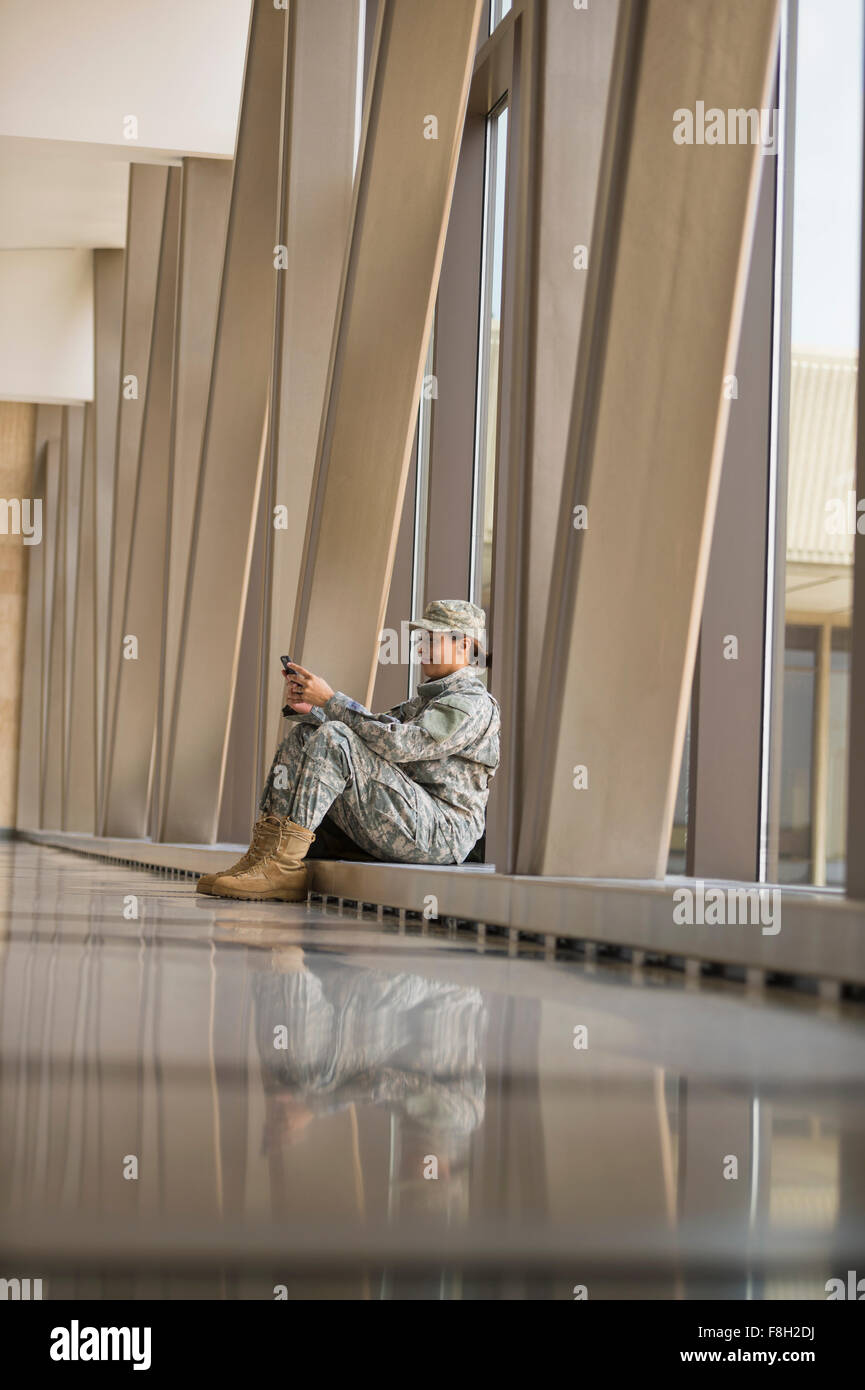 African American soldier using cell phone in airport Stock Photo - Alamy