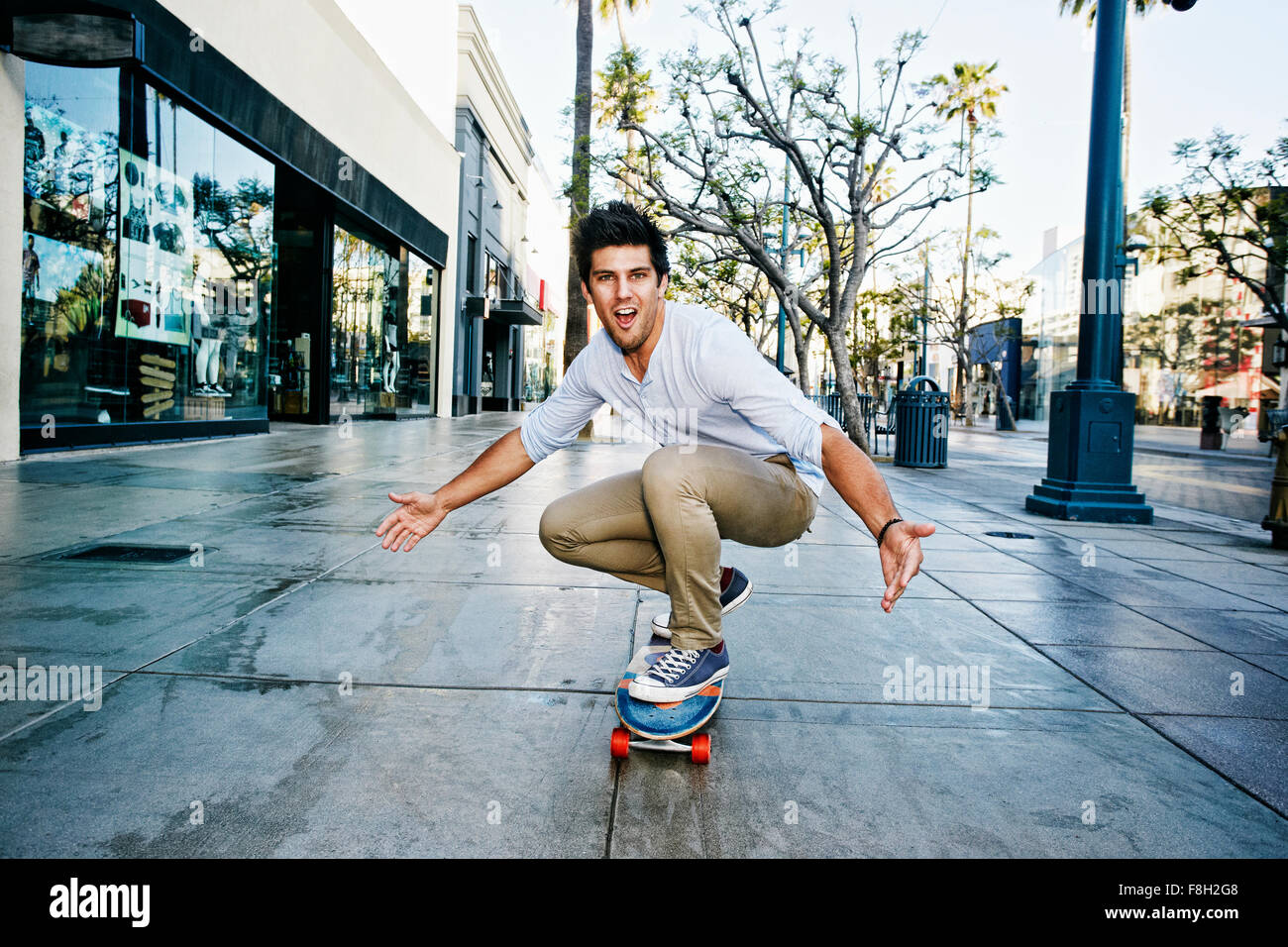 Caucasian man riding skateboard Stock Photo - Alamy