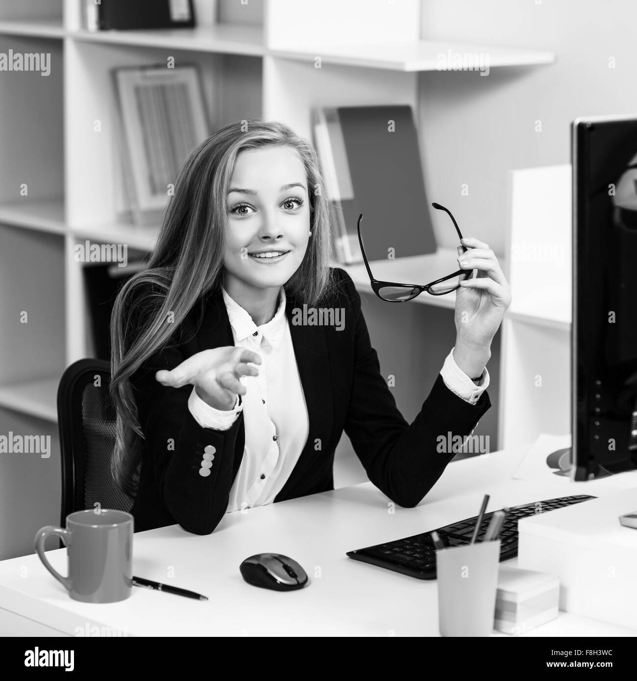 Woman sitting at the desk with computer Stock Photo - Alamy