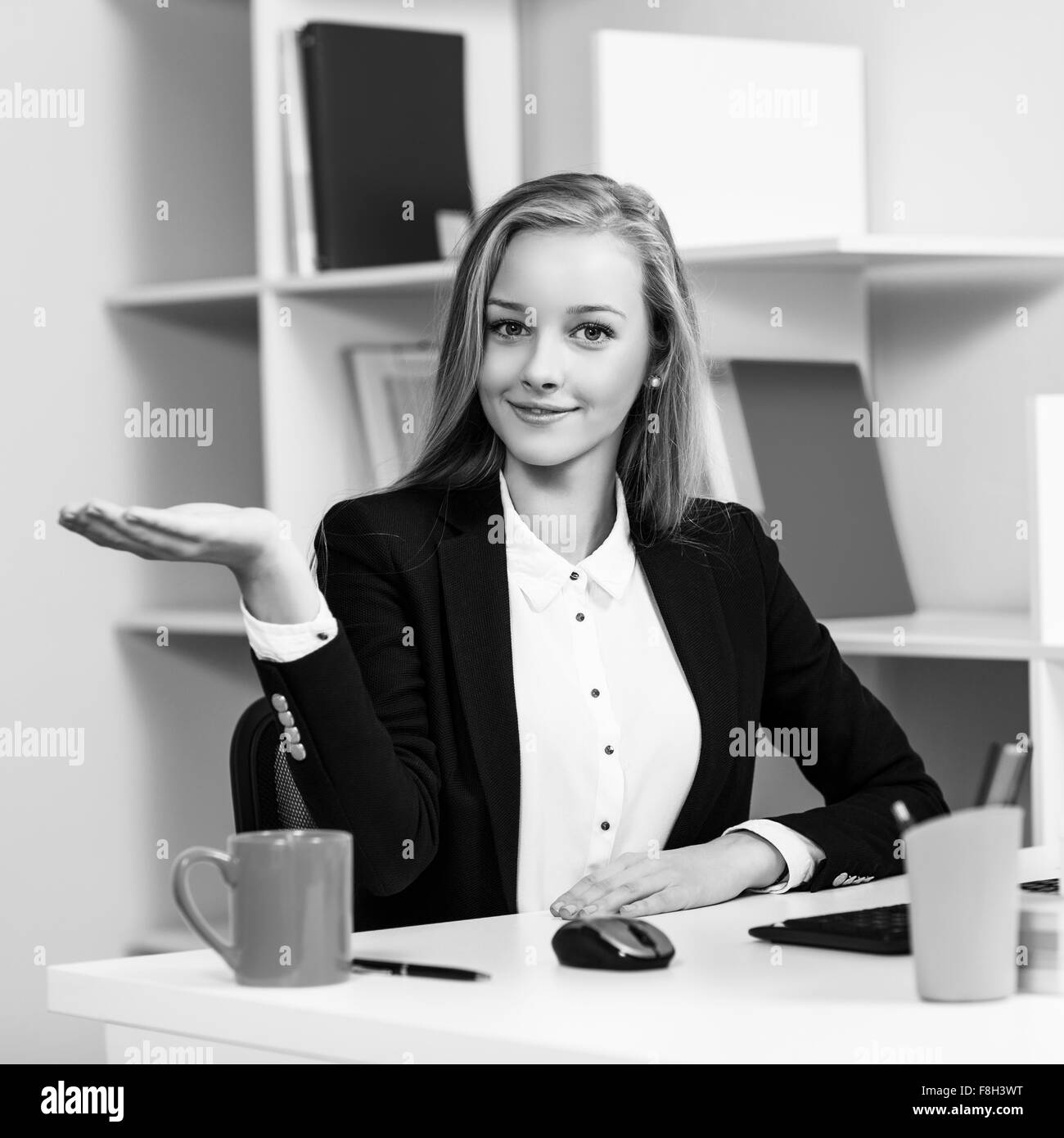 Woman sitting at the desk with computer Stock Photo - Alamy