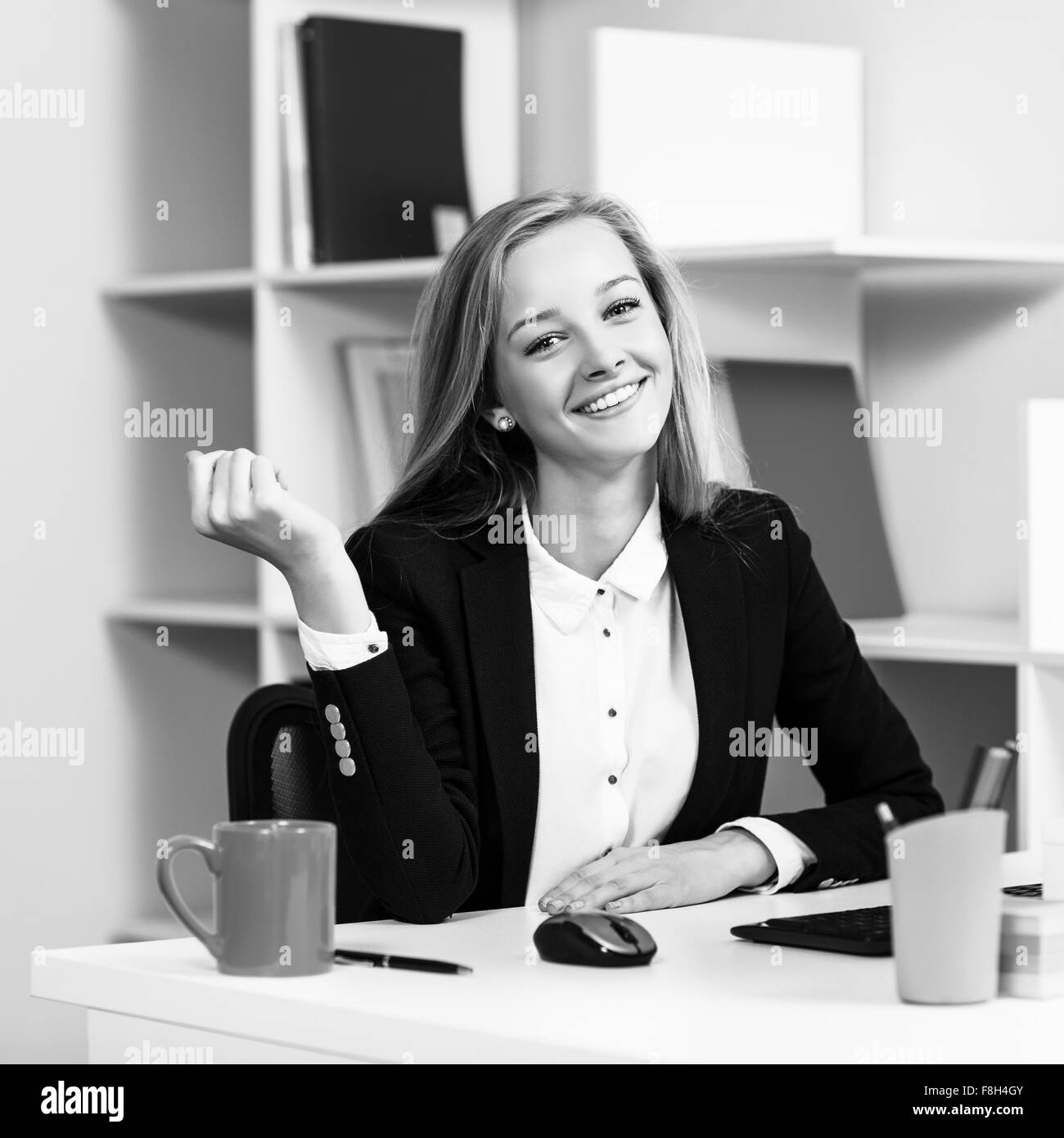 Woman sitting at the desk with computer Stock Photo - Alamy