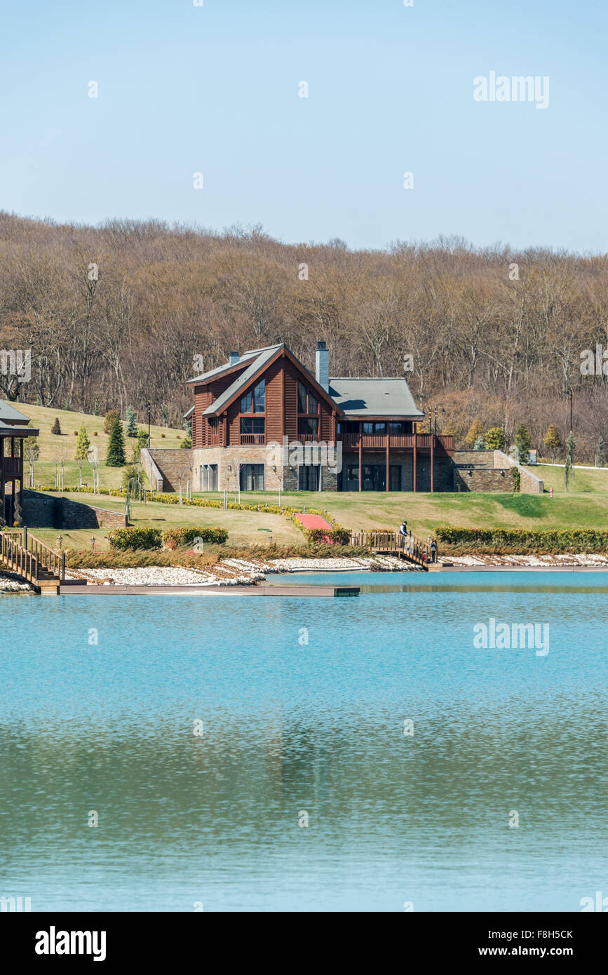 Modern house near water on bright day Stock Photo - Alamy