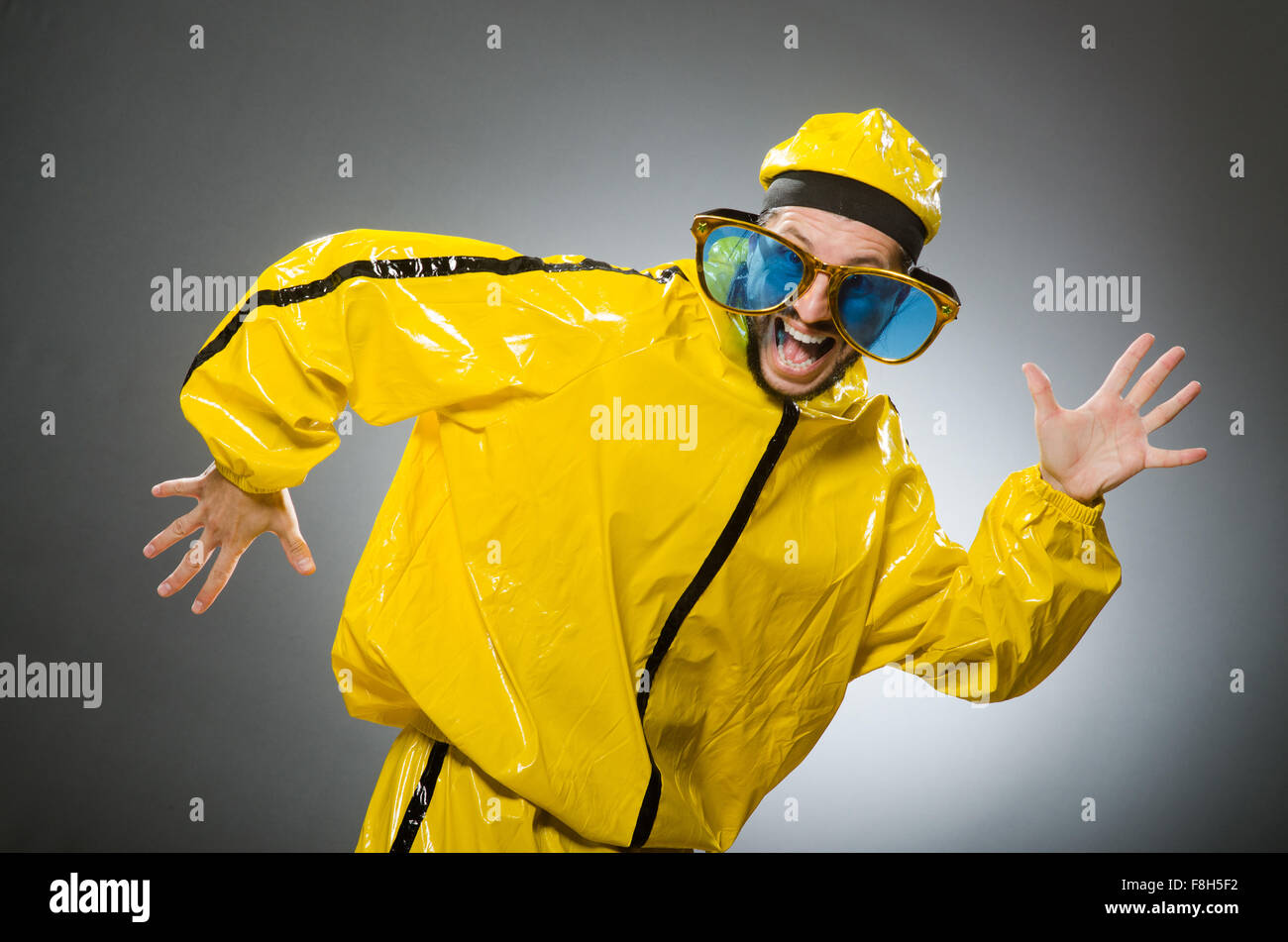 Man wearing yellow suit in funny concept Stock Photo - Alamy