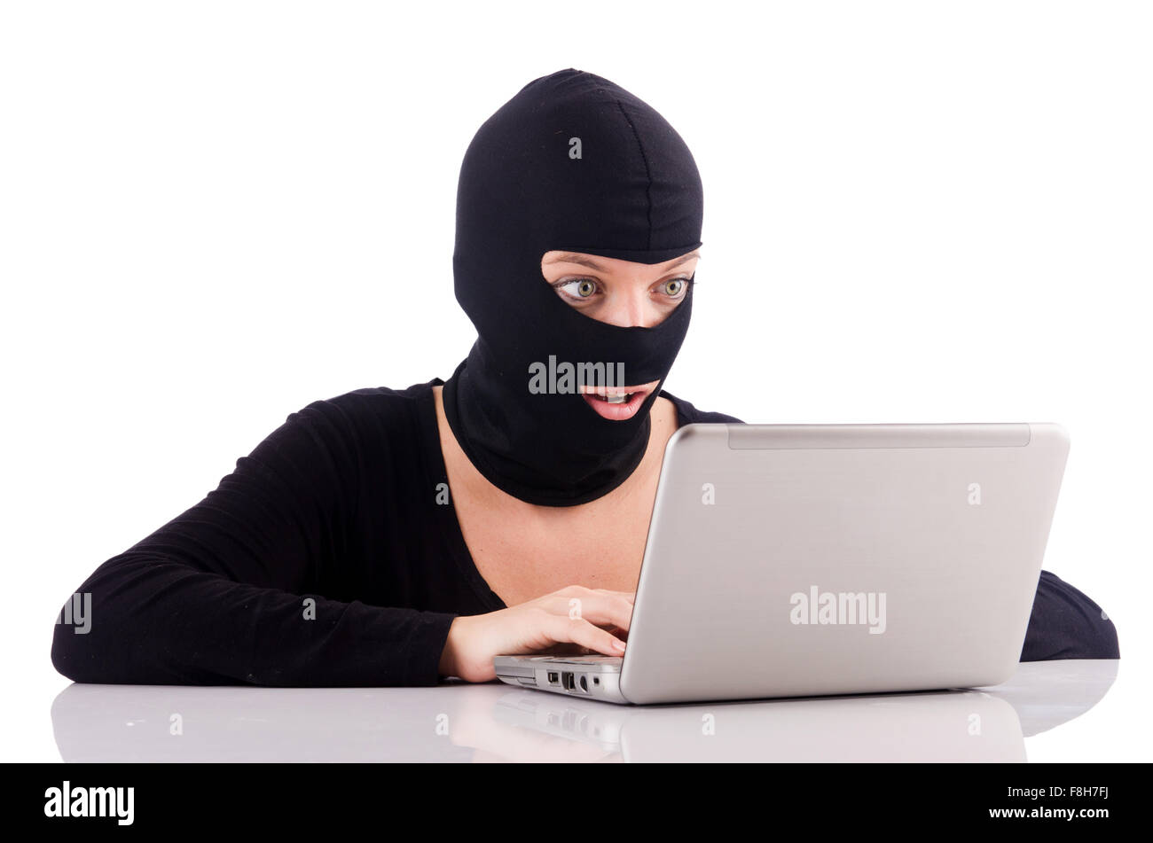 Hacker with computer wearing balaclava Stock Photo - Alamy