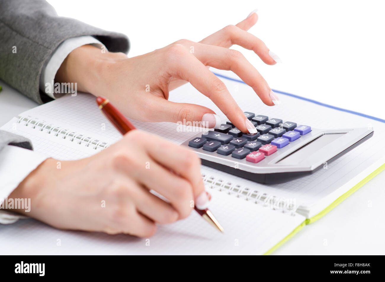 Hands working on the calculator Stock Photo - Alamy