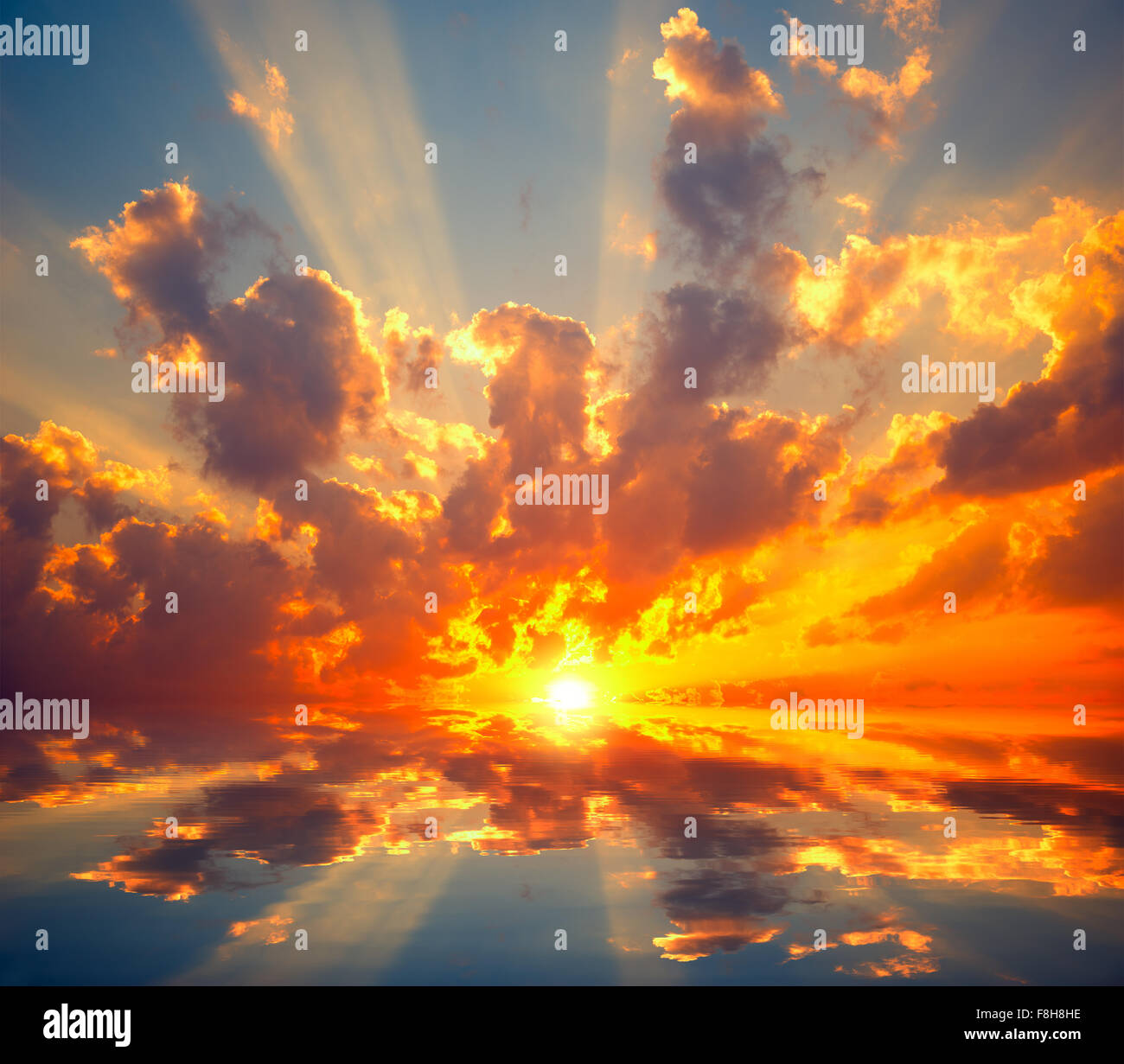 Sunset sky over the surface of the water Stock Photo - Alamy