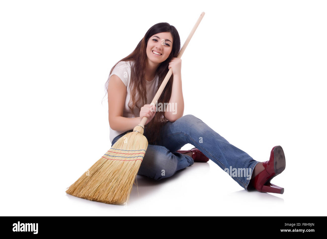 Young woman with broom isolated on white Stock Photo - Alamy