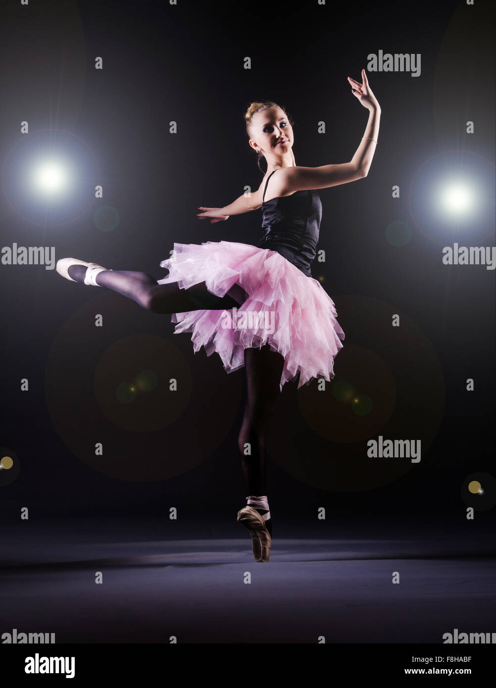 Ballerina dancing in the dark studio Stock Photo - Alamy