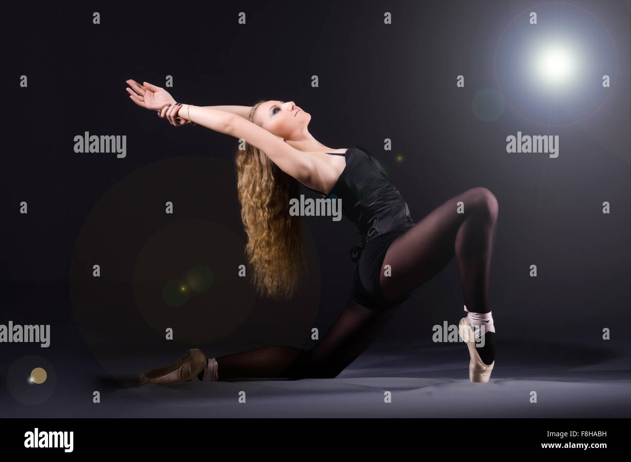 Ballerina dancing in the dark studio Stock Photo - Alamy