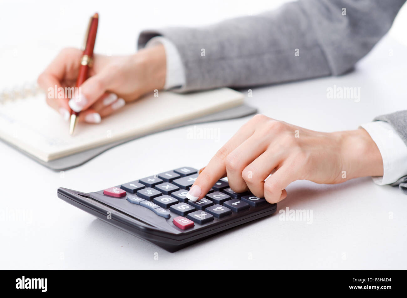 Hands working on the calculator Stock Photo - Alamy