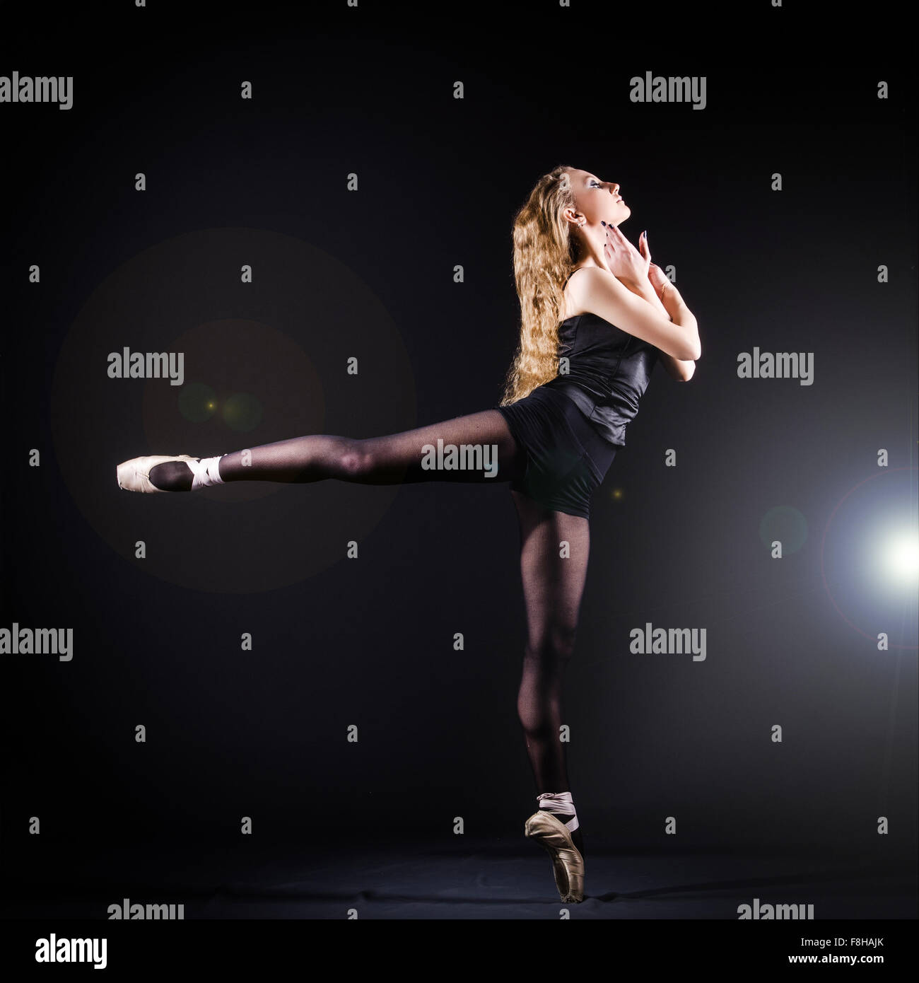 Ballerina dancing in the dark studio Stock Photo - Alamy