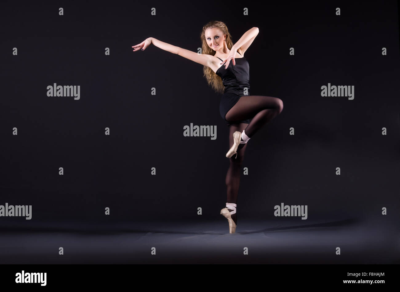 Ballerina dancing in the dark studio Stock Photo - Alamy