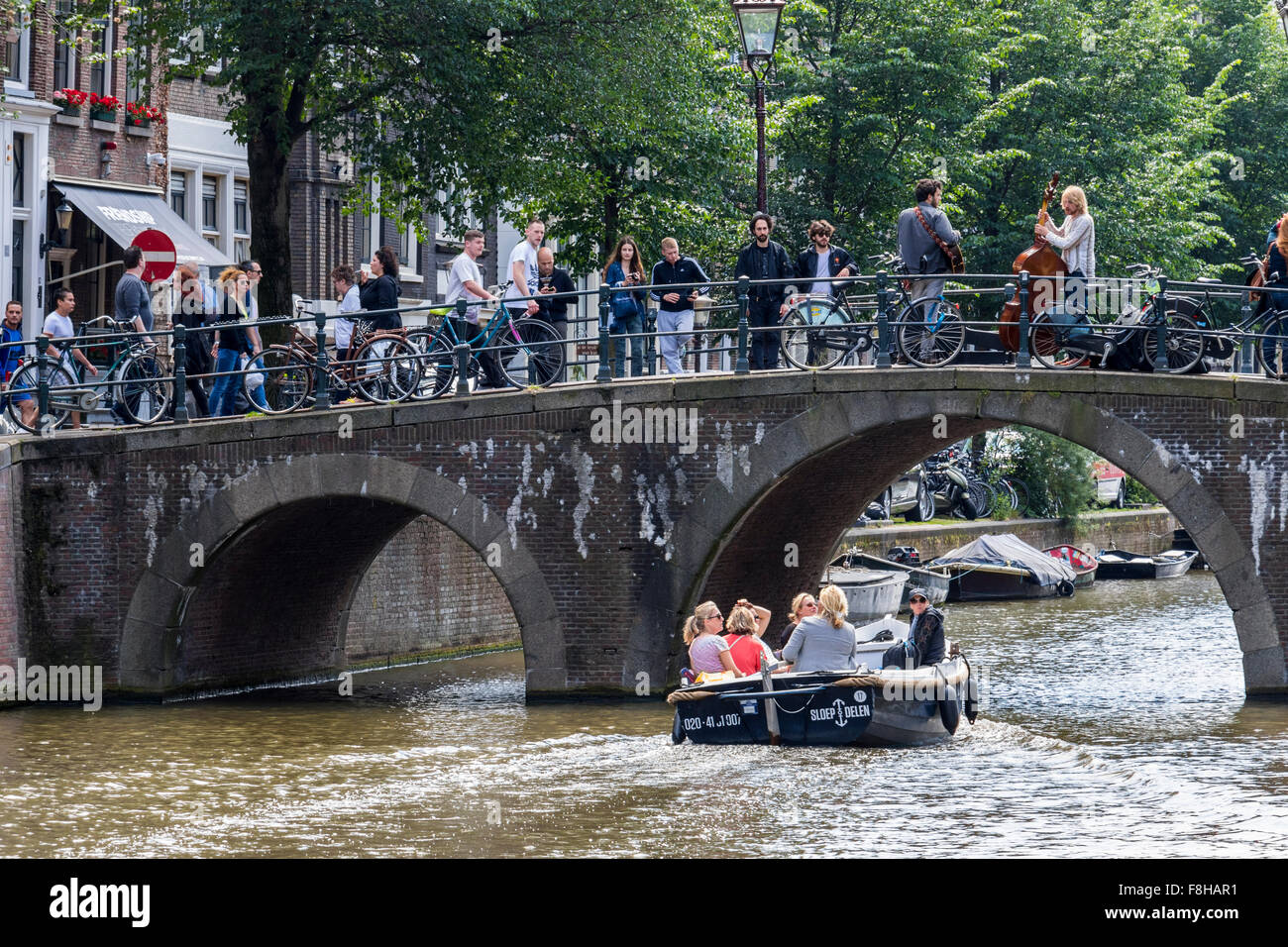 Small boat moving along one of Holland's many canals in city of ...
