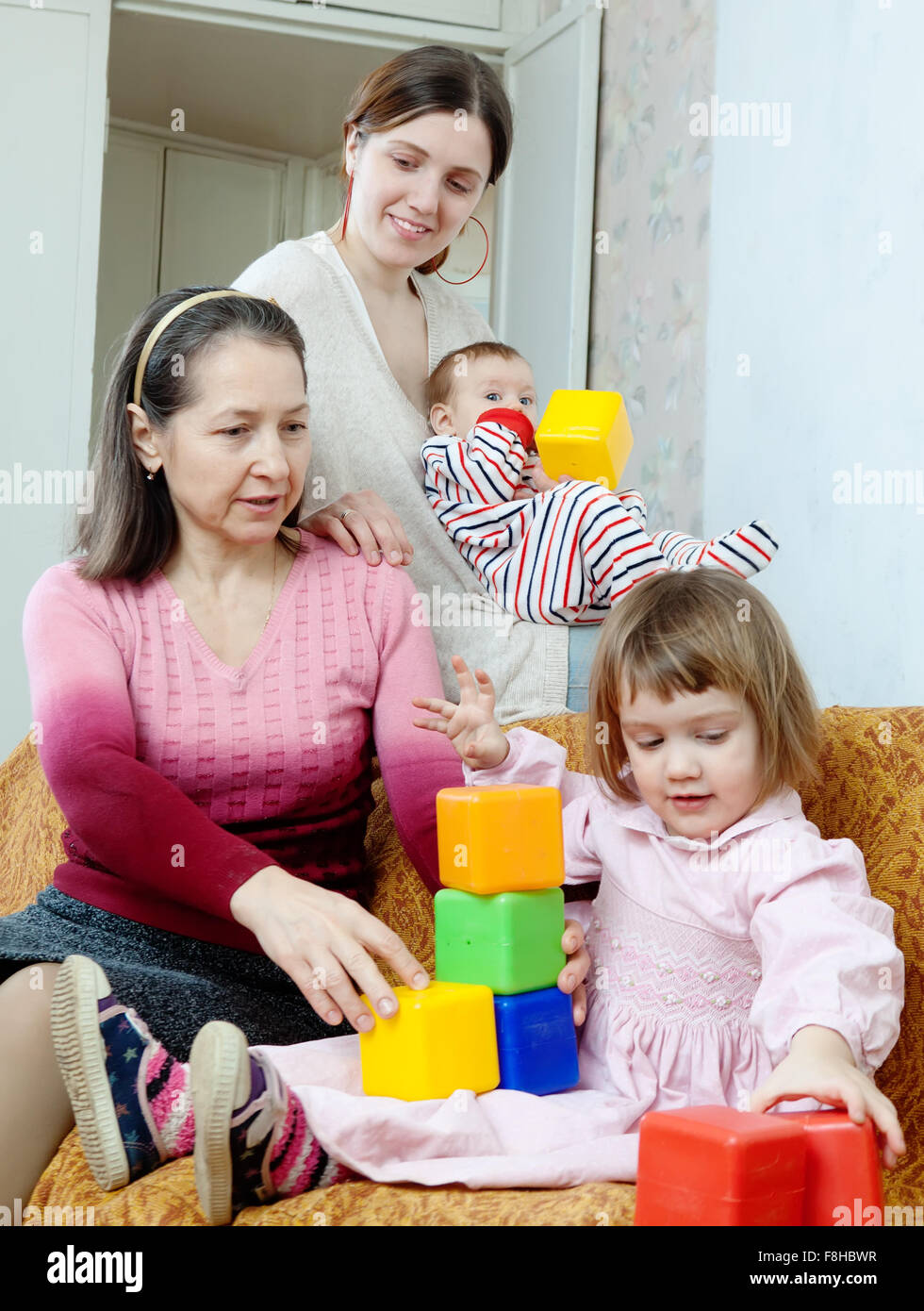 Happy women with children in home Stock Photo - Alamy