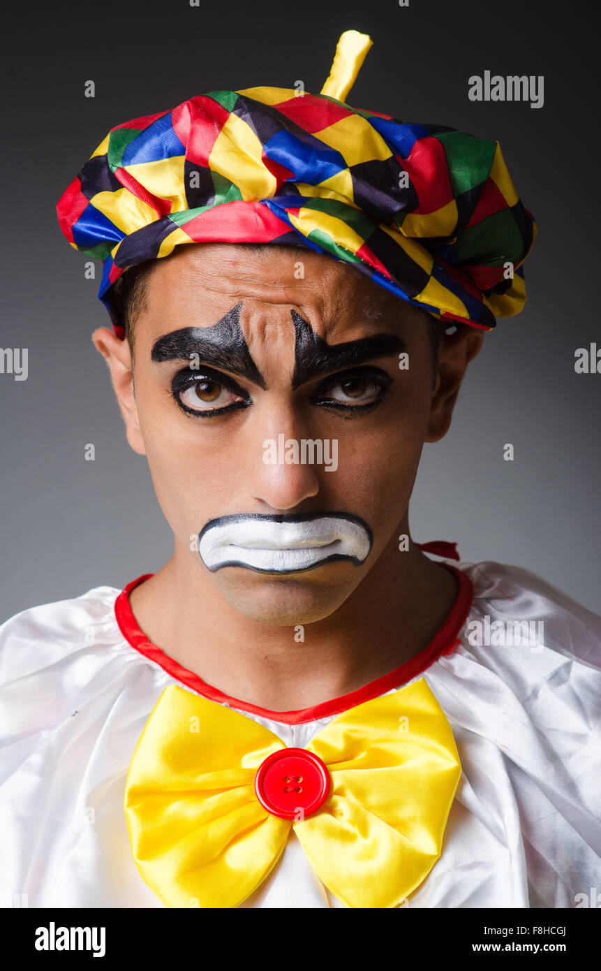Sad clown against dark background Stock Photo - Alamy