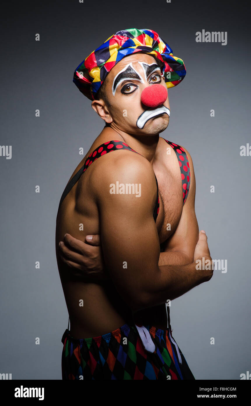 Sad clown against dark background Stock Photo - Alamy