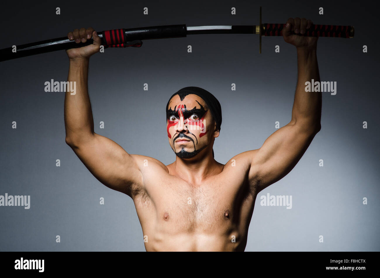 Man with sword and face paint Stock Photo - Alamy