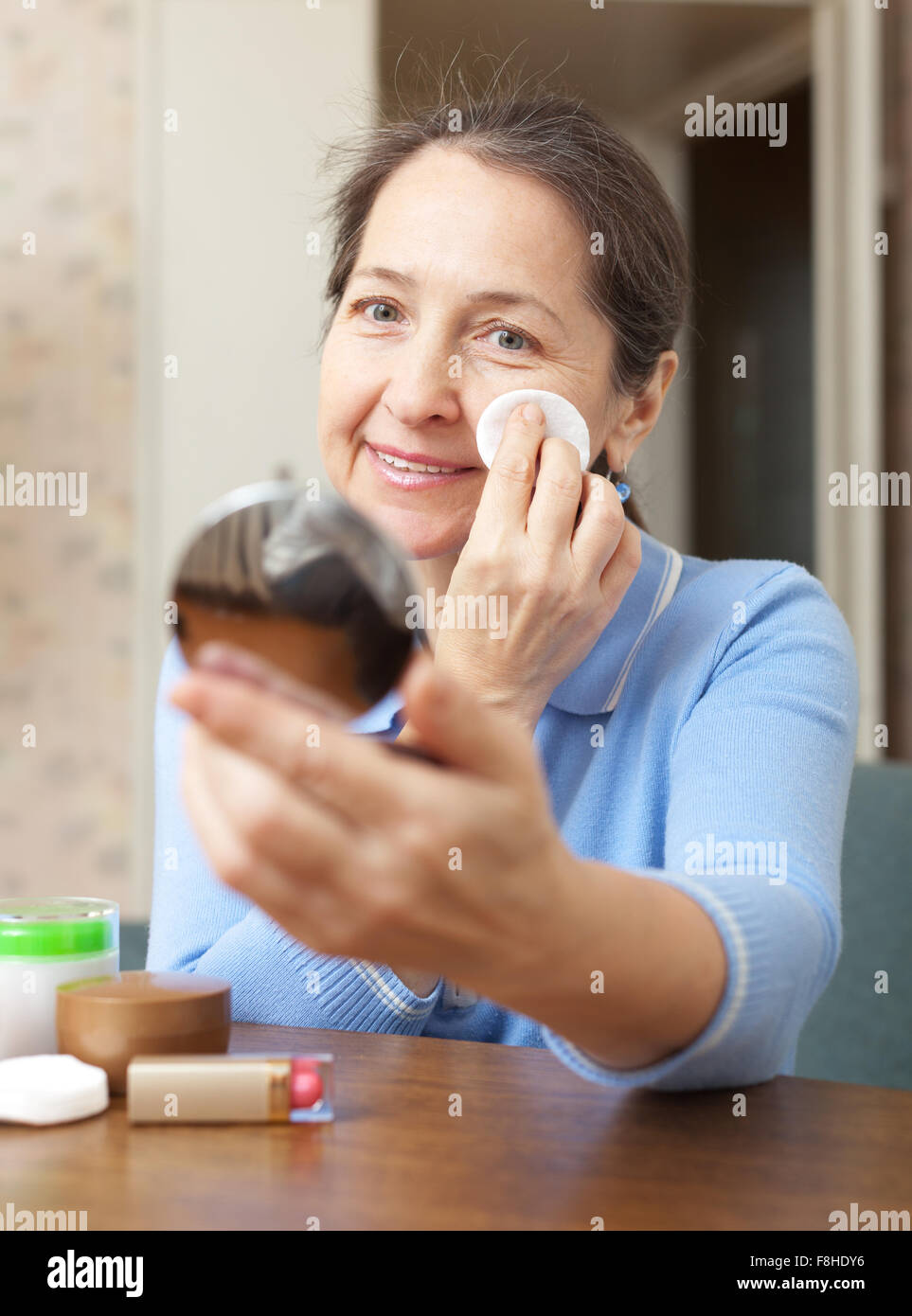 woman cleans the make-up from face Stock Photo - Alamy