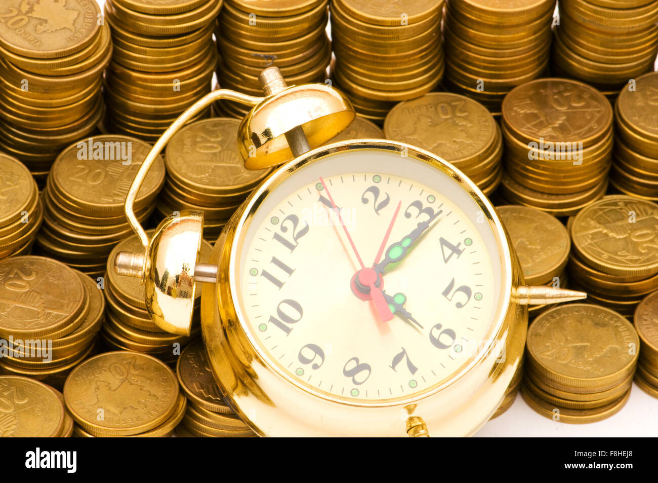 Time is money concept with clock and coins Stock Photo - Alamy