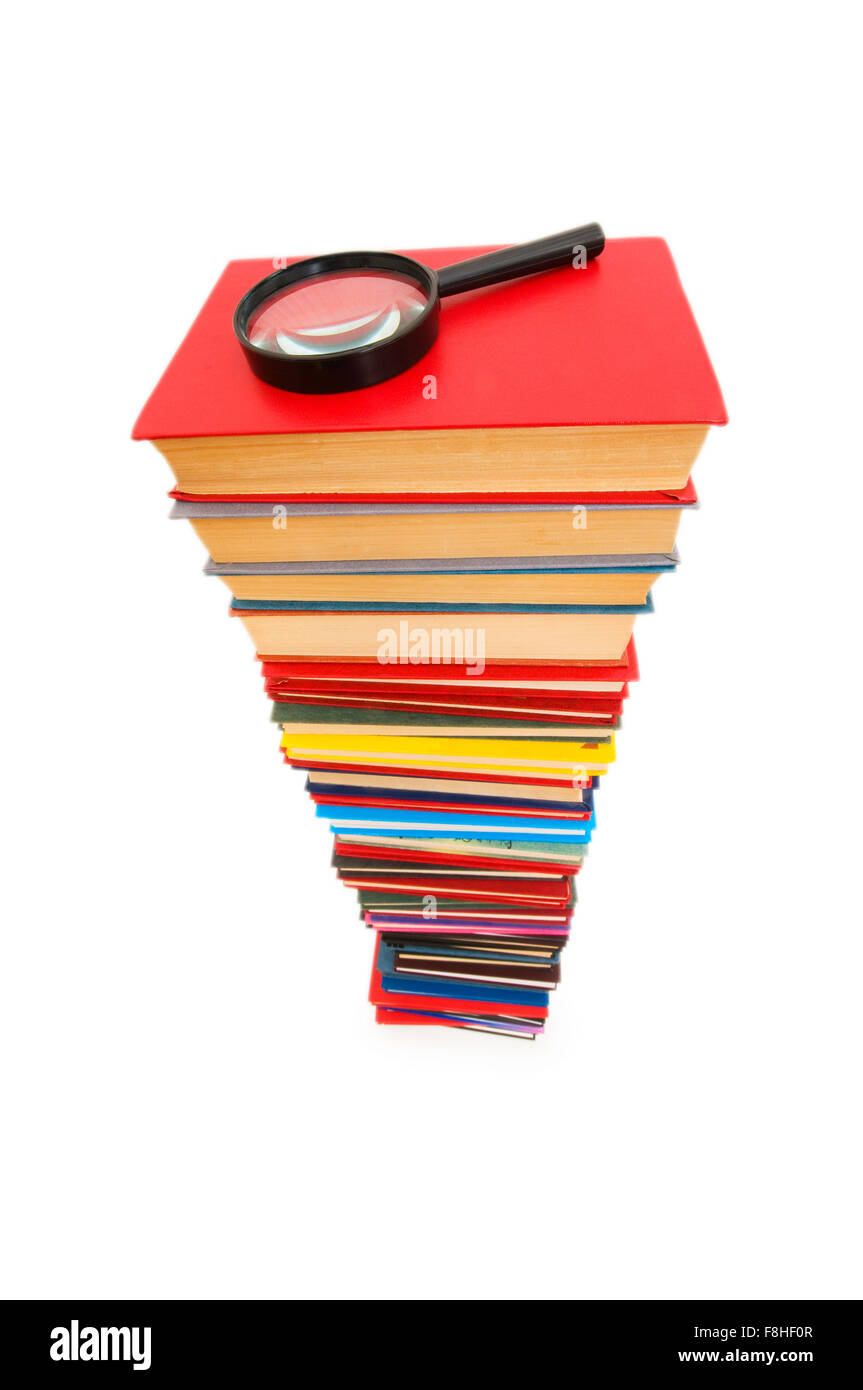 Magnifying glass over the stack of books Stock Photo - Alamy