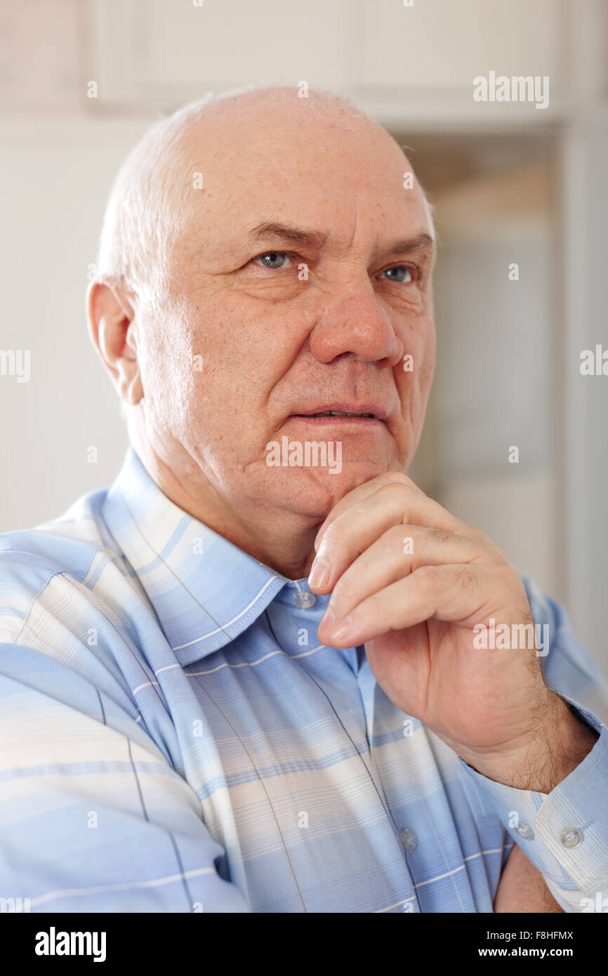 portrait of wistful senior man in interior Stock Photo - Alamy